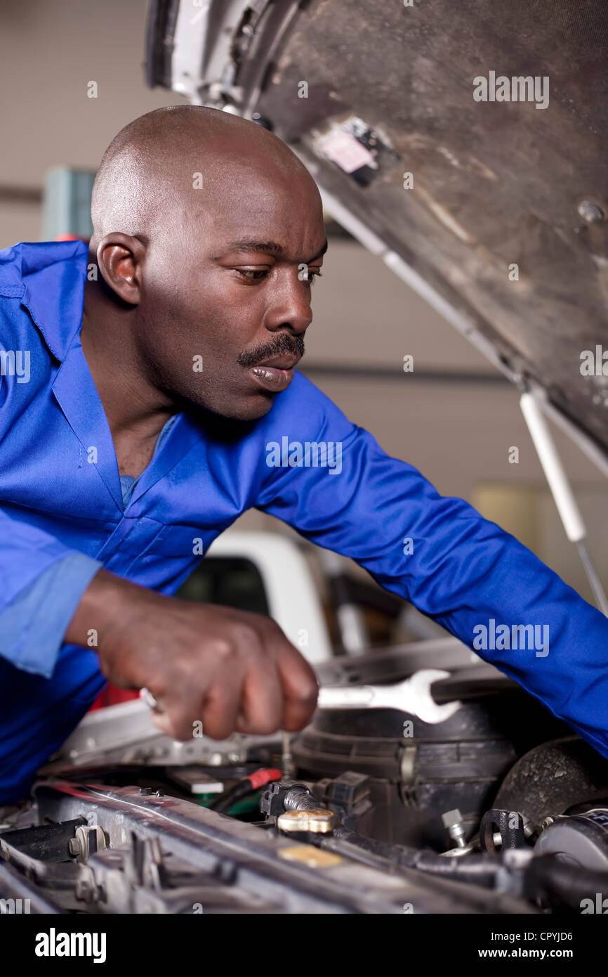 African man working on a car engine Stock Photo - Alamy