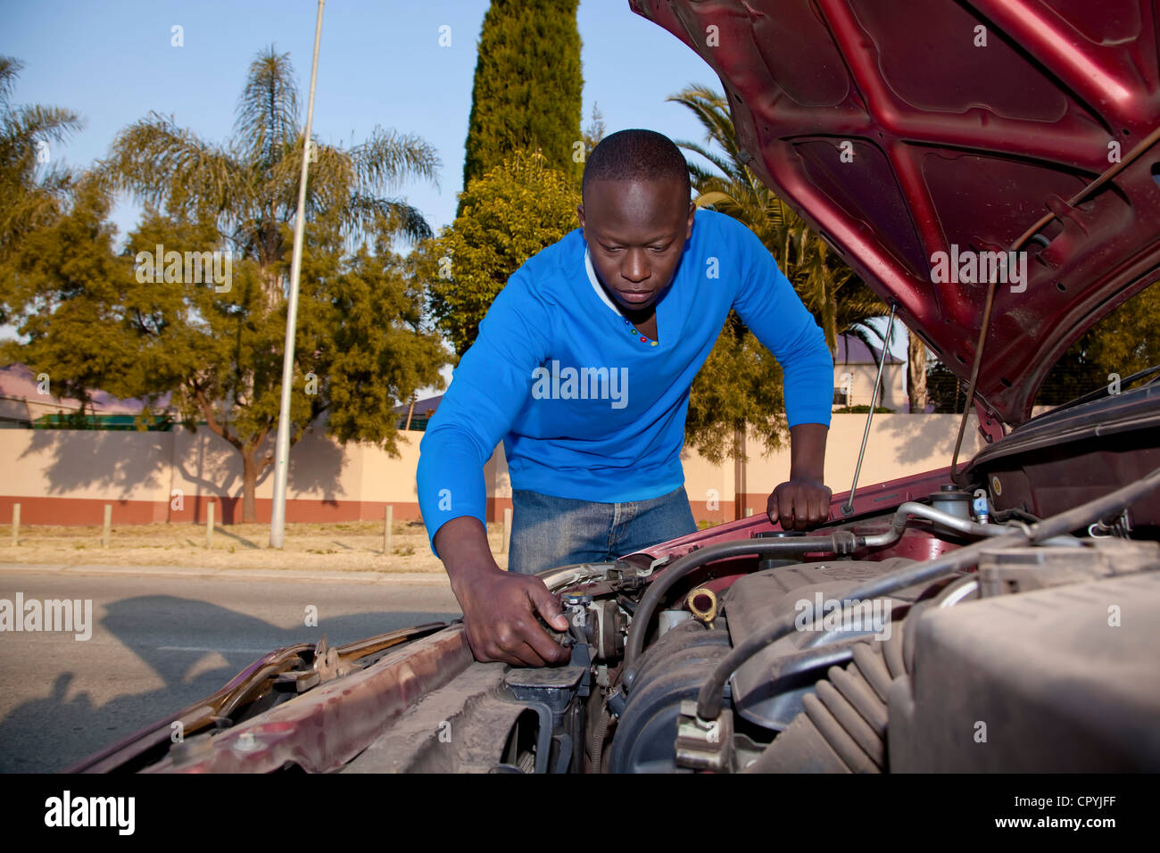 African man working on a car engine Stock Photo - Alamy