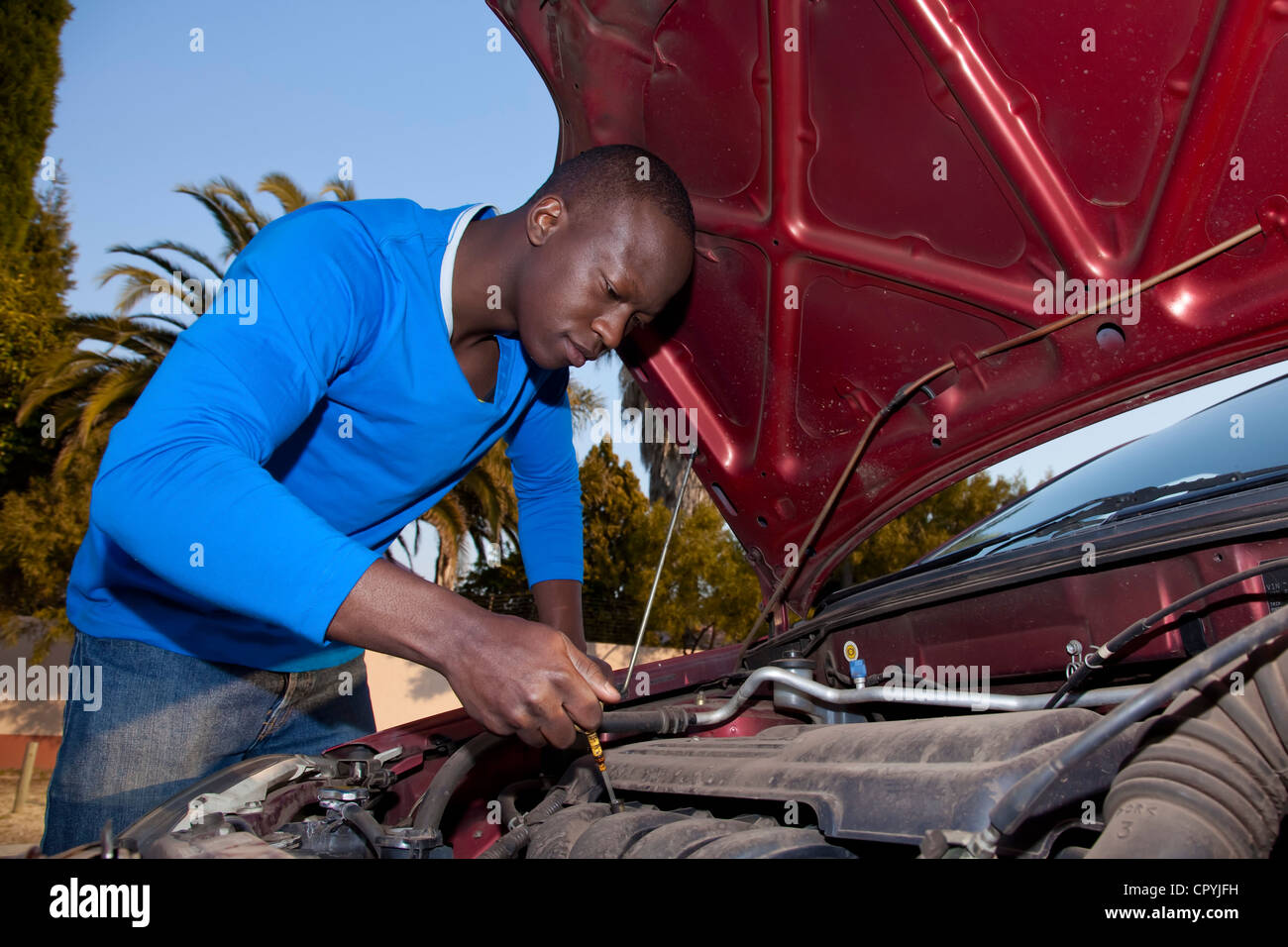 African man working on a car engine Stock Photo - Alamy