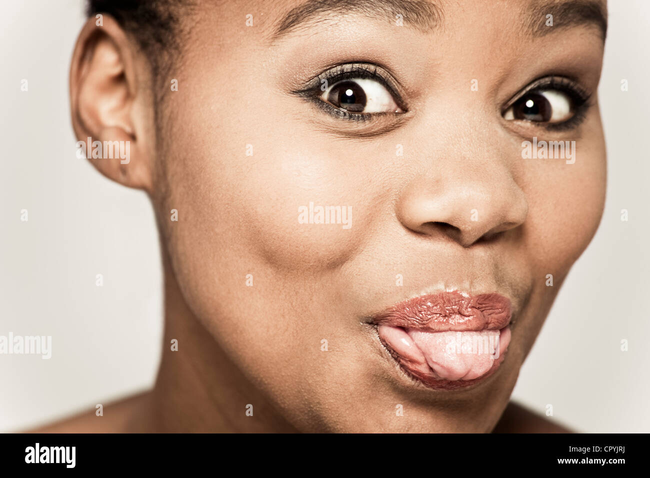Woman sticking out tongue pulling hi-res stock photography and images - Alamy