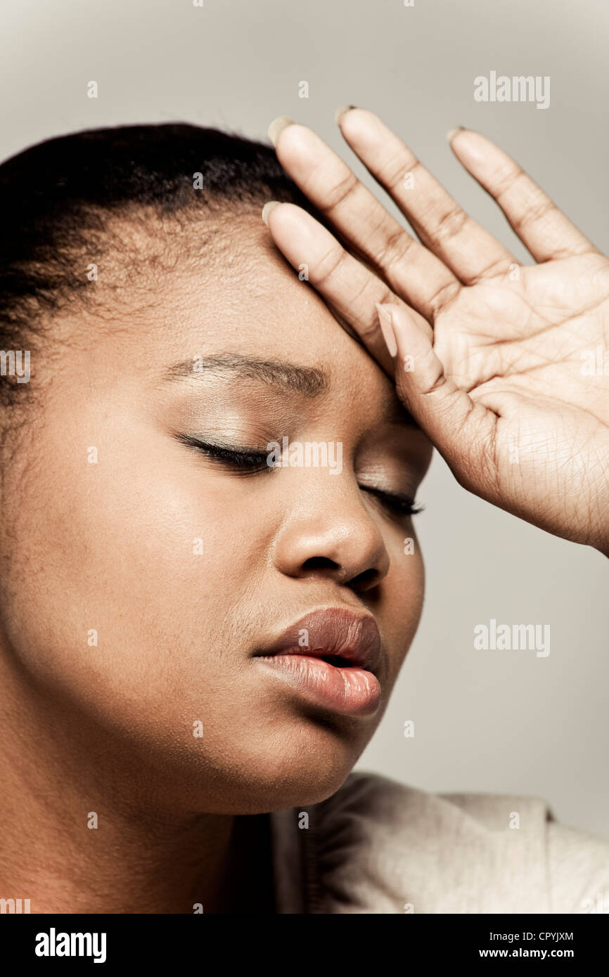 Portrait of young black woman, looking feint Stock Photo - Alamy