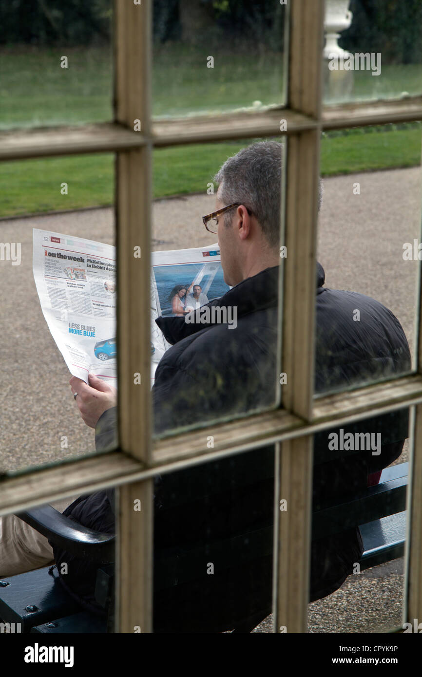 Looking through window with man reading newspaper in park Sheffield ...