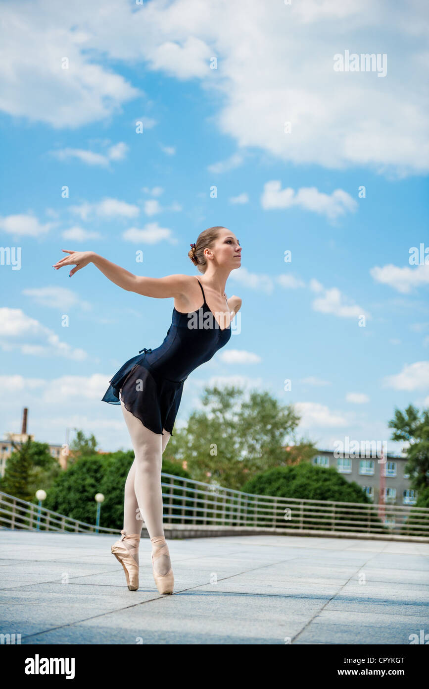 Ballet dancer dancing outdoor with blue sky in background Stock Photo ...