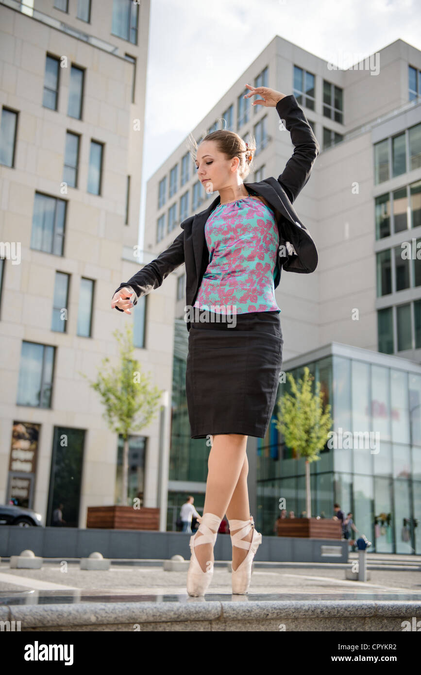 Ballet dancer dressed in business clothes dancing on street Stock Photo ...