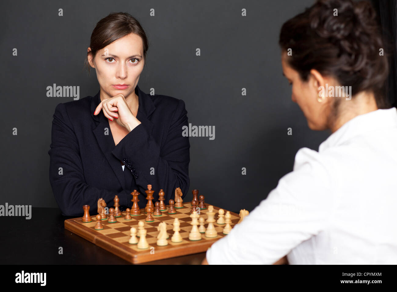 Two women playing chess Stock Photo - Alamy