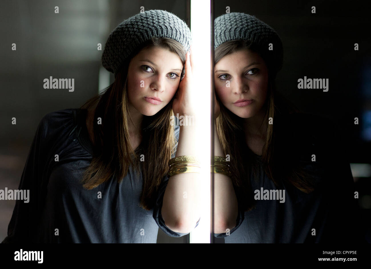 Young woman in front of a glass wall, portrait with reflection Stock ...