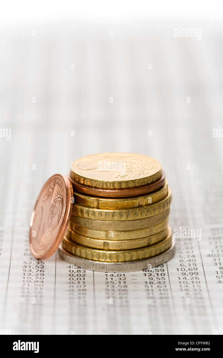 Stack of coins on stock prices Stock Photo - Alamy