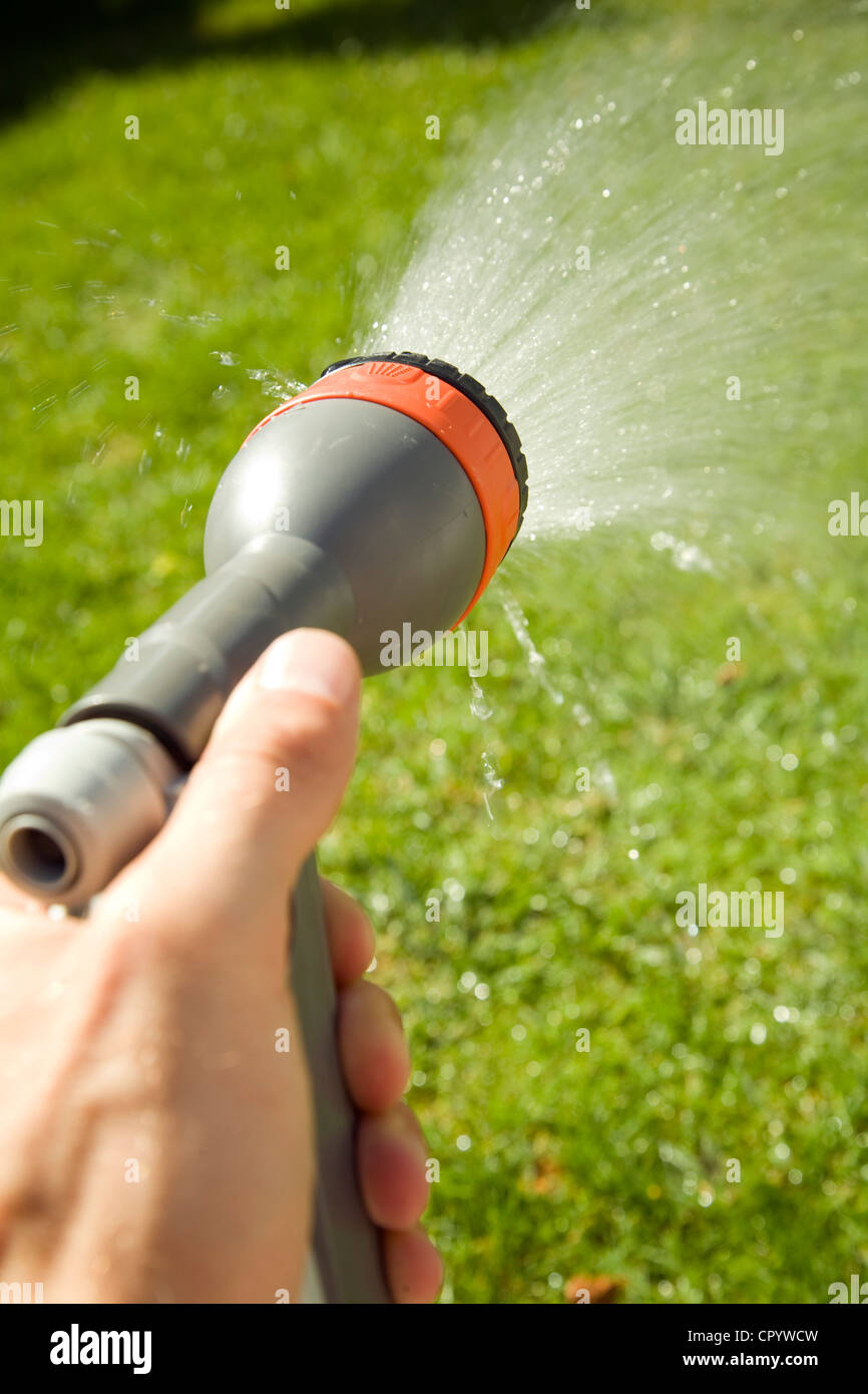 Lawn being watered Stock Photo - Alamy