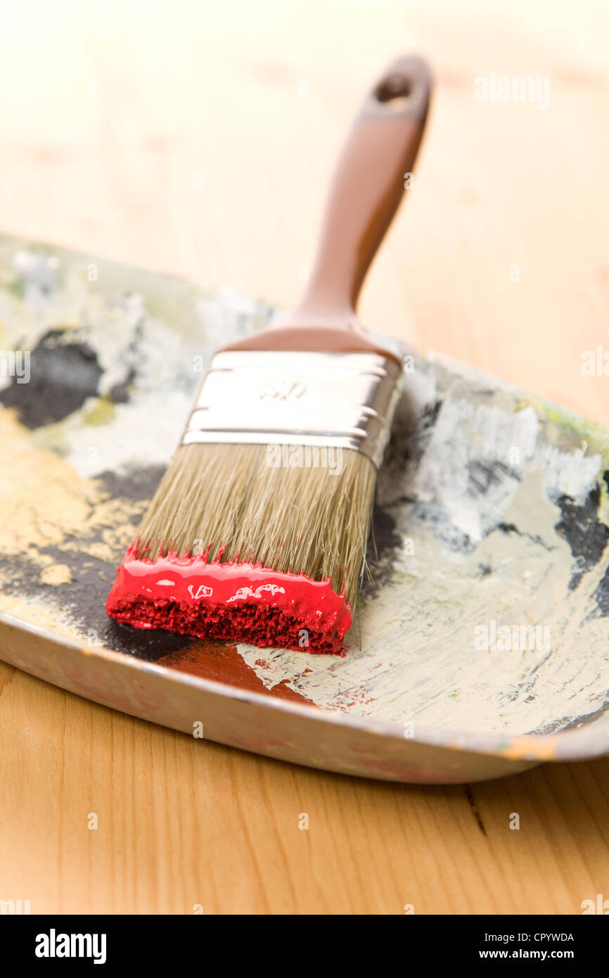 Paintbrush with paint in a bowl Stock Photo - Alamy