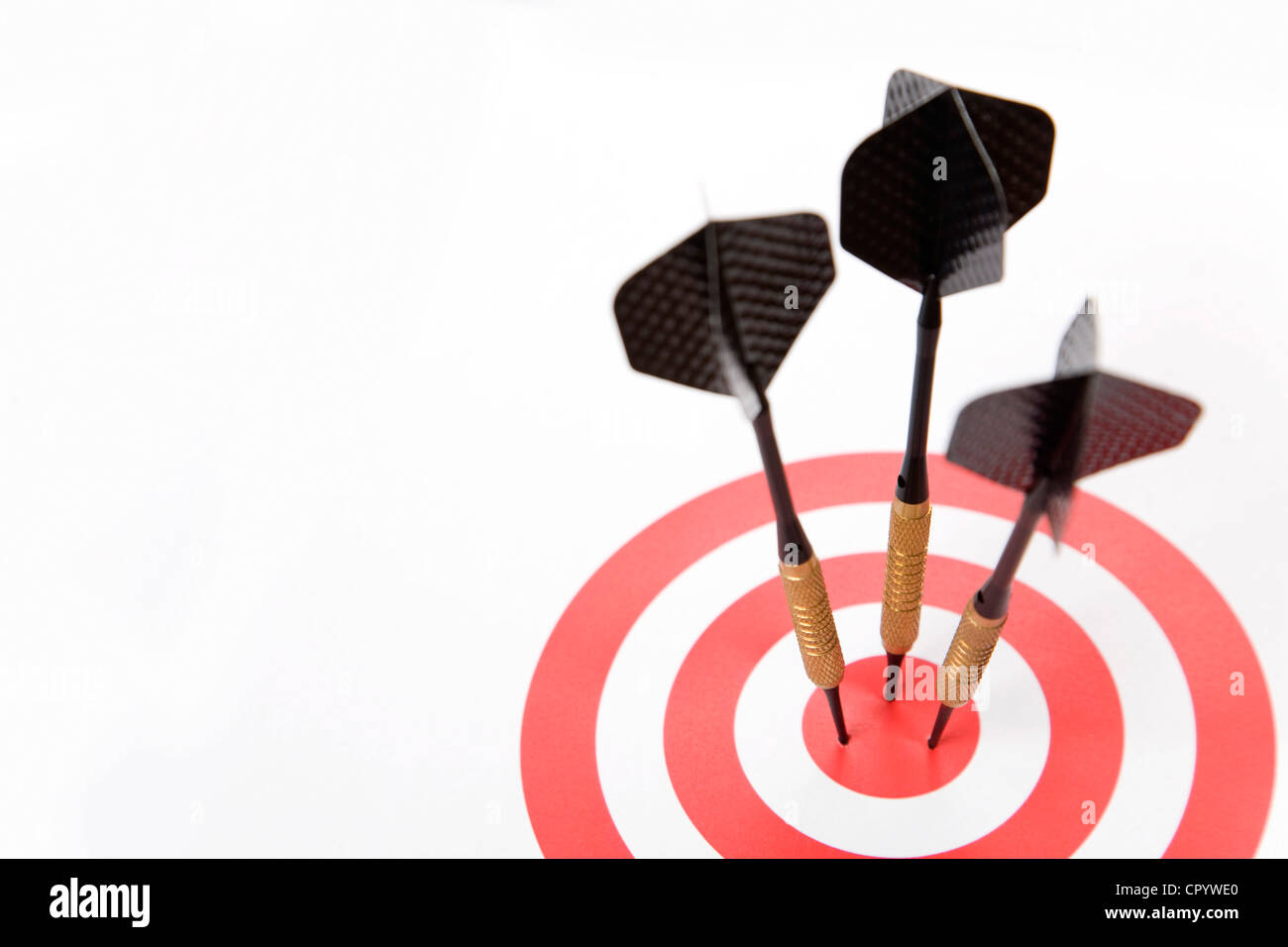 Three darts in a target Stock Photo - Alamy
