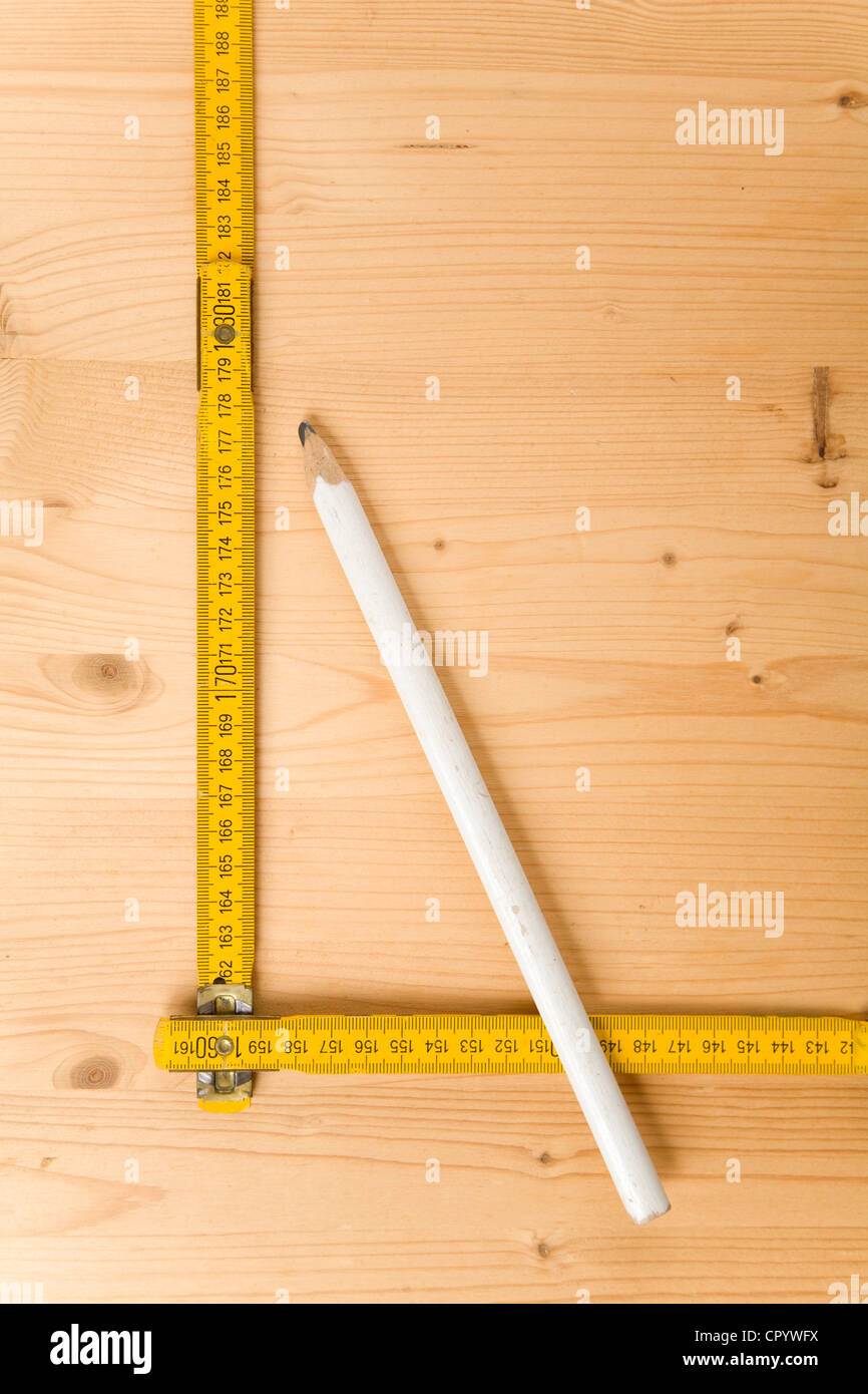 Pencil with a folding carpenter's ruler Stock Photo - Alamy