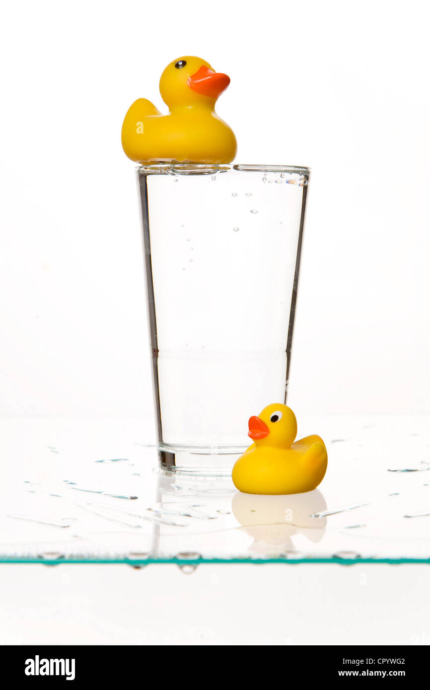 Glass with yellow rubber ducks Stock Photo - Alamy
