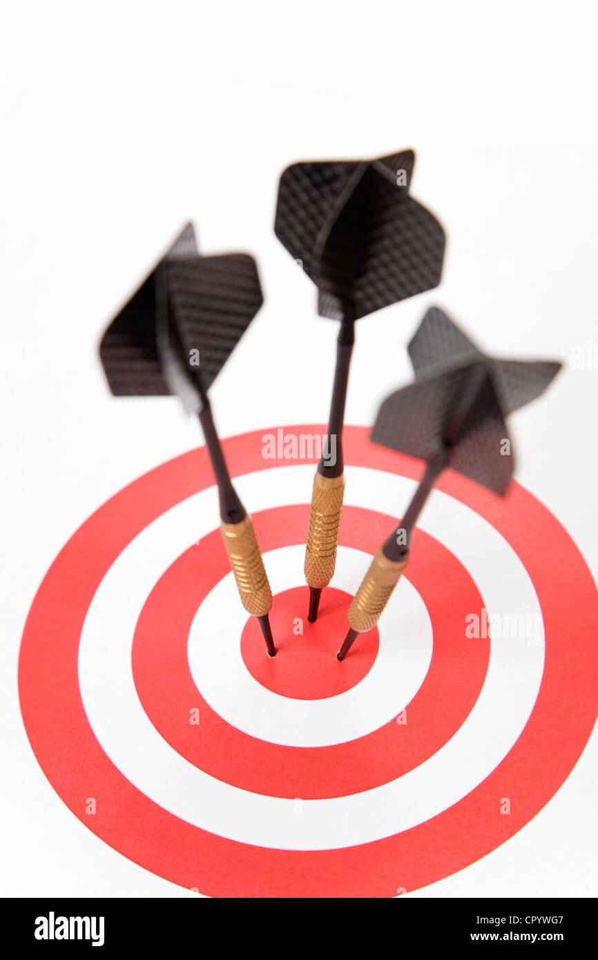 Three darts in a target Stock Photo - Alamy