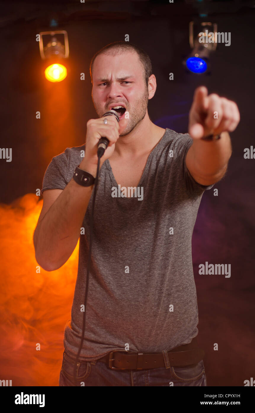 Singer with microphone in hand Stock Photo - Alamy