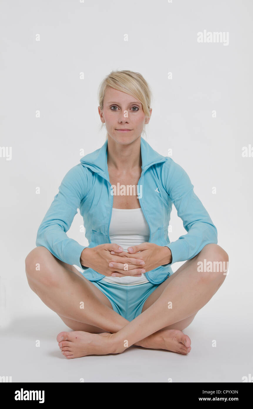Young woman sitting cross-legged on the floor Stock Photo - Alamy