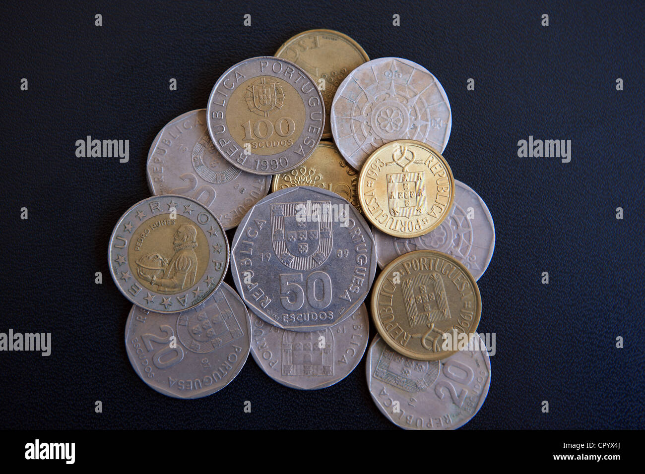 Portuguese Escudo coins on a black background Stock Photo - Alamy