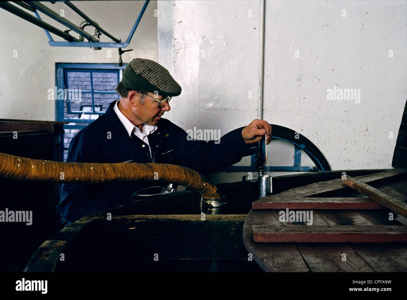 Scottish whiskey distillery worker checks mash tun Stock Photo - Alamy