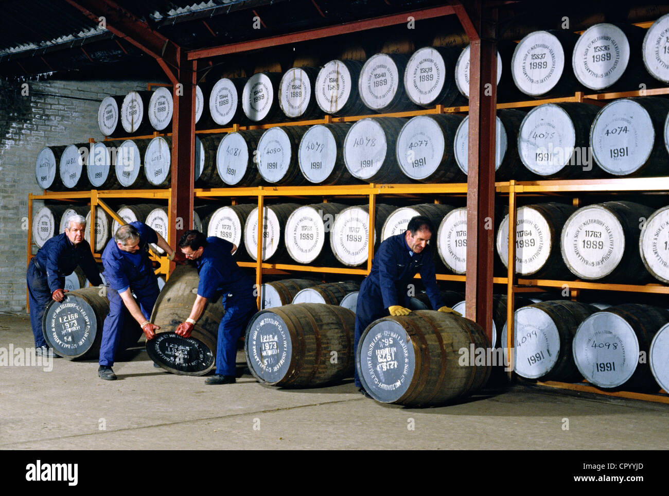 MiltonDuff distillery workers moving casks of whiskey Stock Photo - Alamy