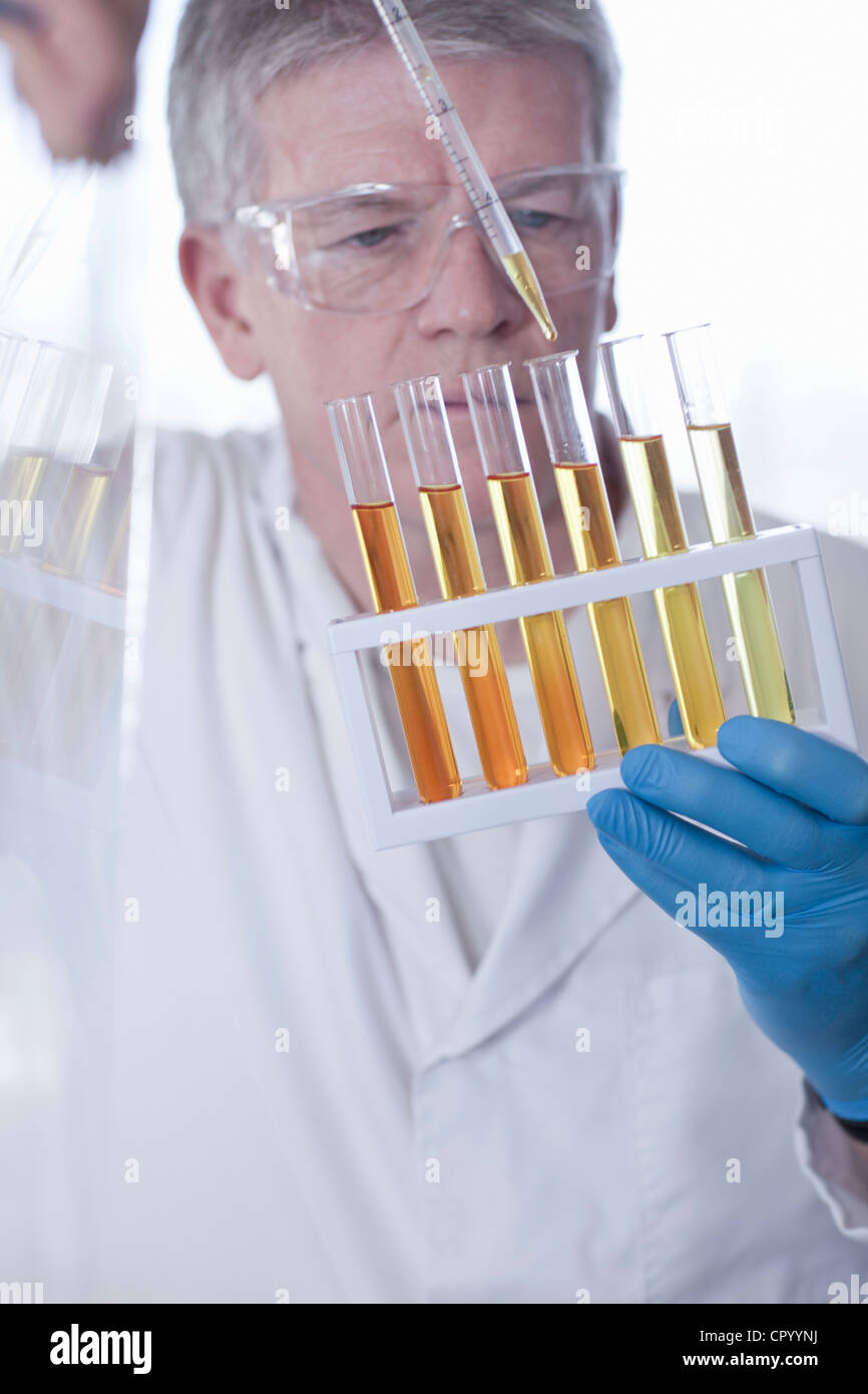 Scientist dropping liquid test tubes hi-res stock photography and ...