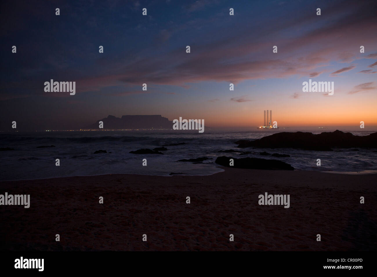 Sunset over off coast oil rig Stock Photo - Alamy