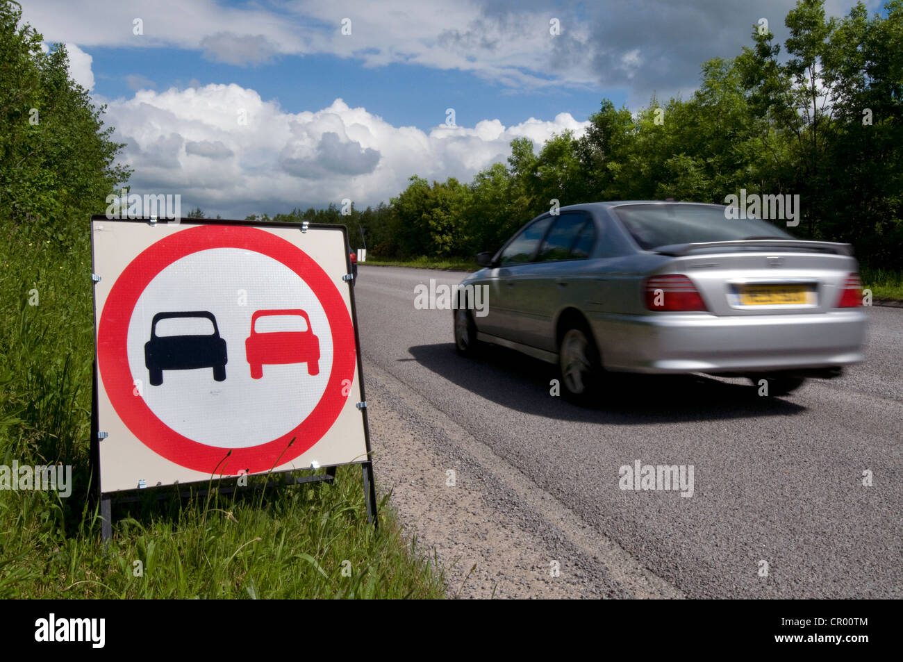car passing no overtaking warning sign due to loose chippings on newly ...