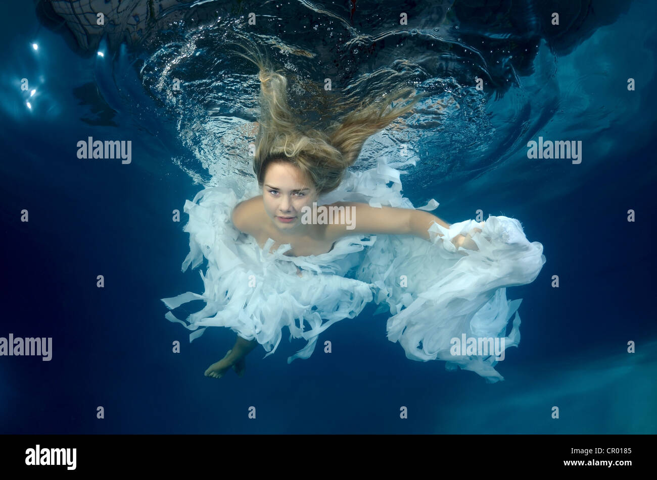 Woman presenting underwater fashion in a pool Stock Photo - Alamy