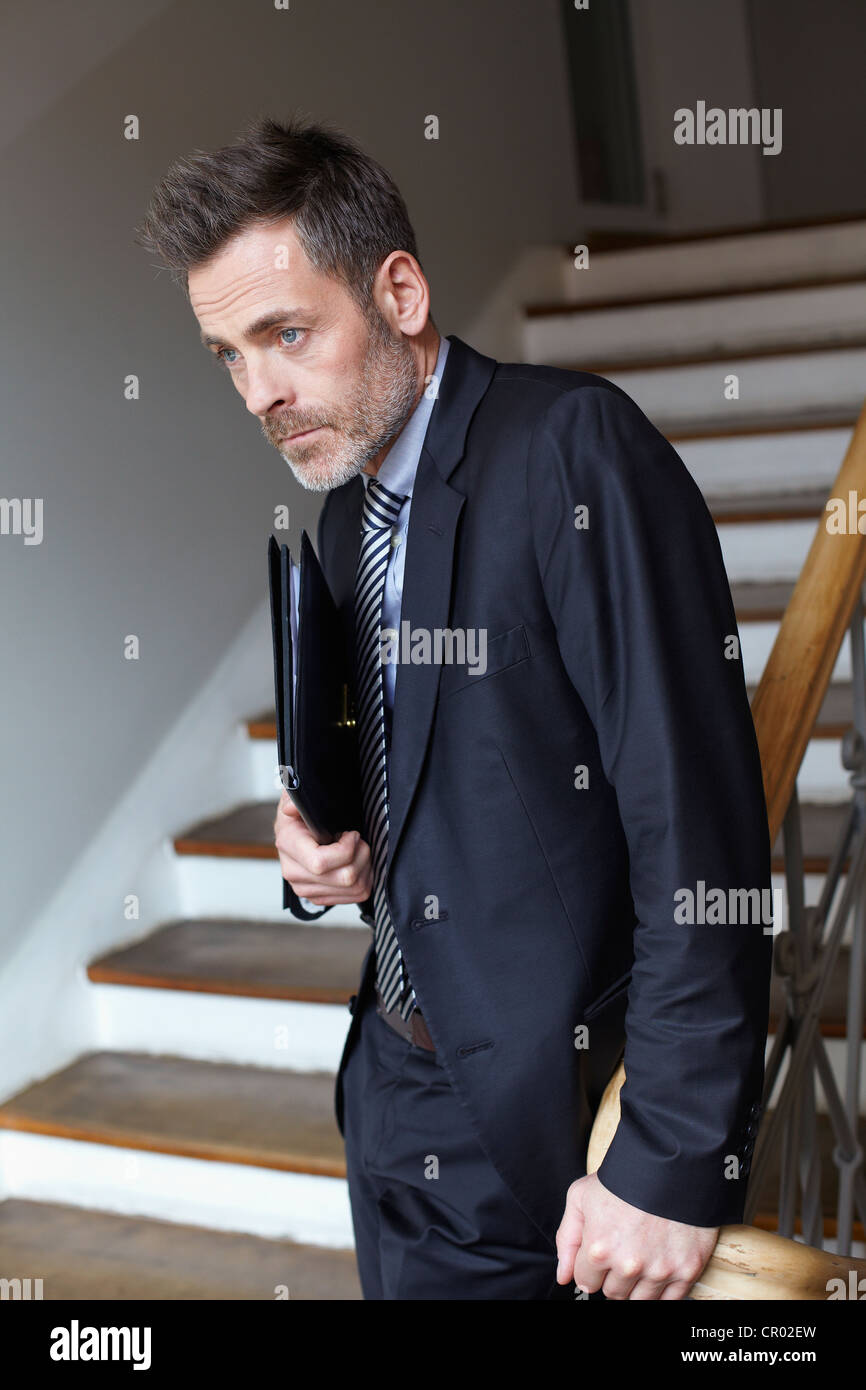 Pensive businessman leaning on railing hi-res stock photography and ...