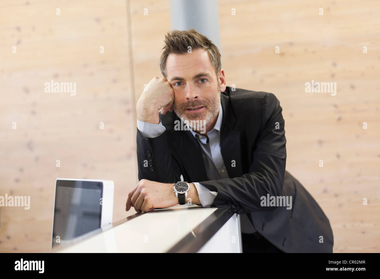 Businessman on counter in office Stock Photo - Alamy