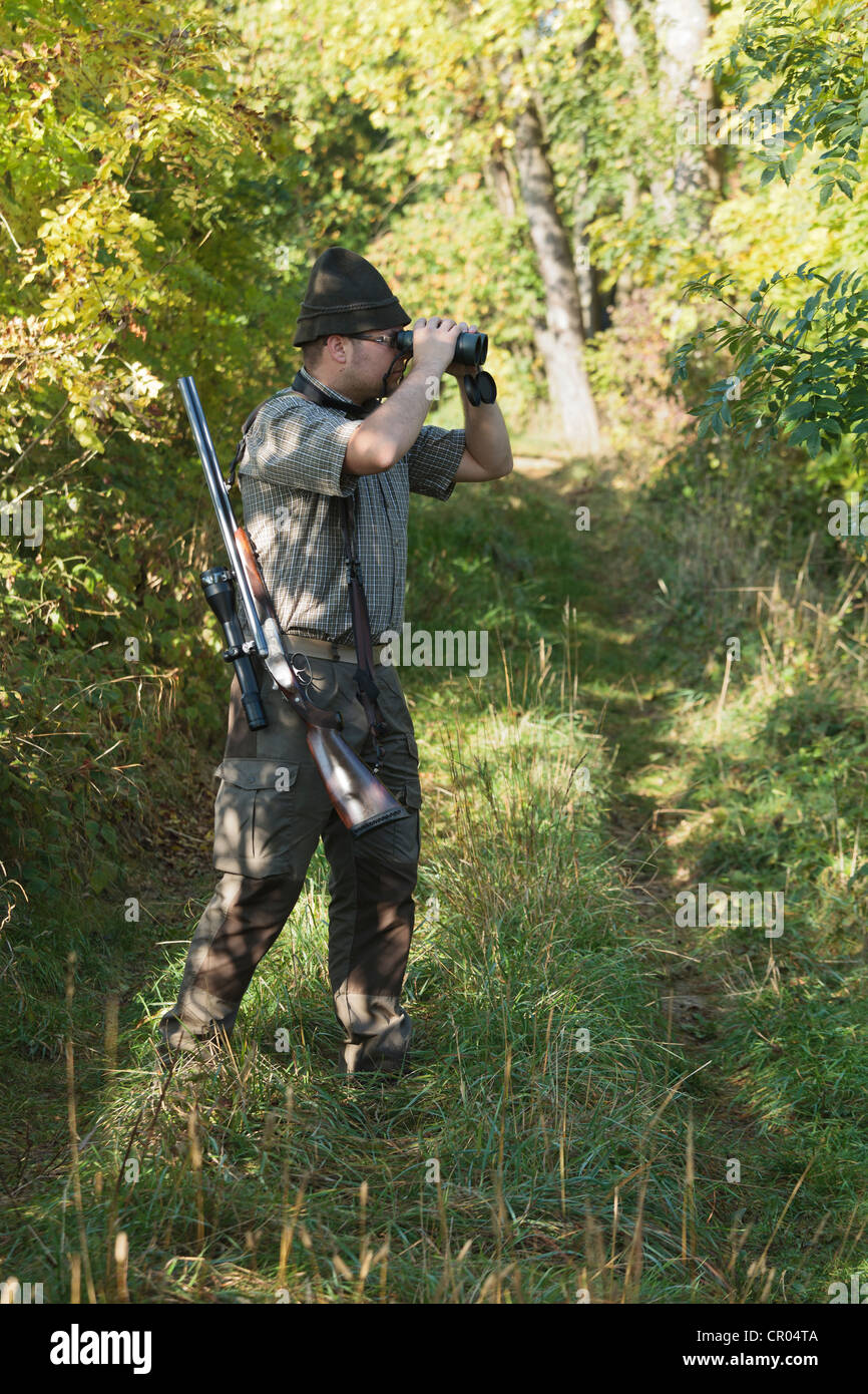 Hunter observing quarry Stock Photo - Alamy