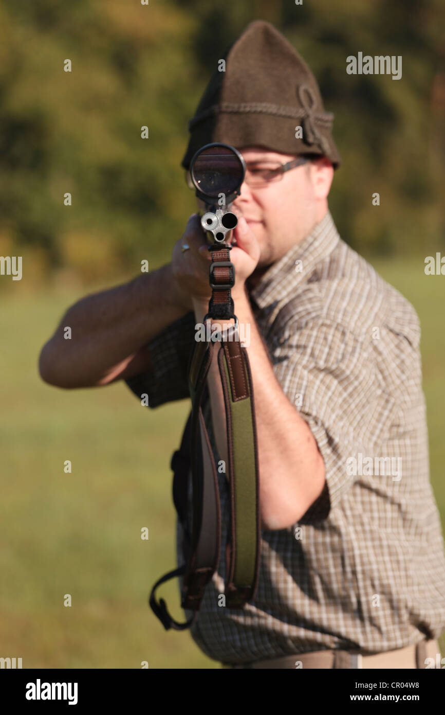 Hunter with a rifle at the ready Stock Photo - Alamy