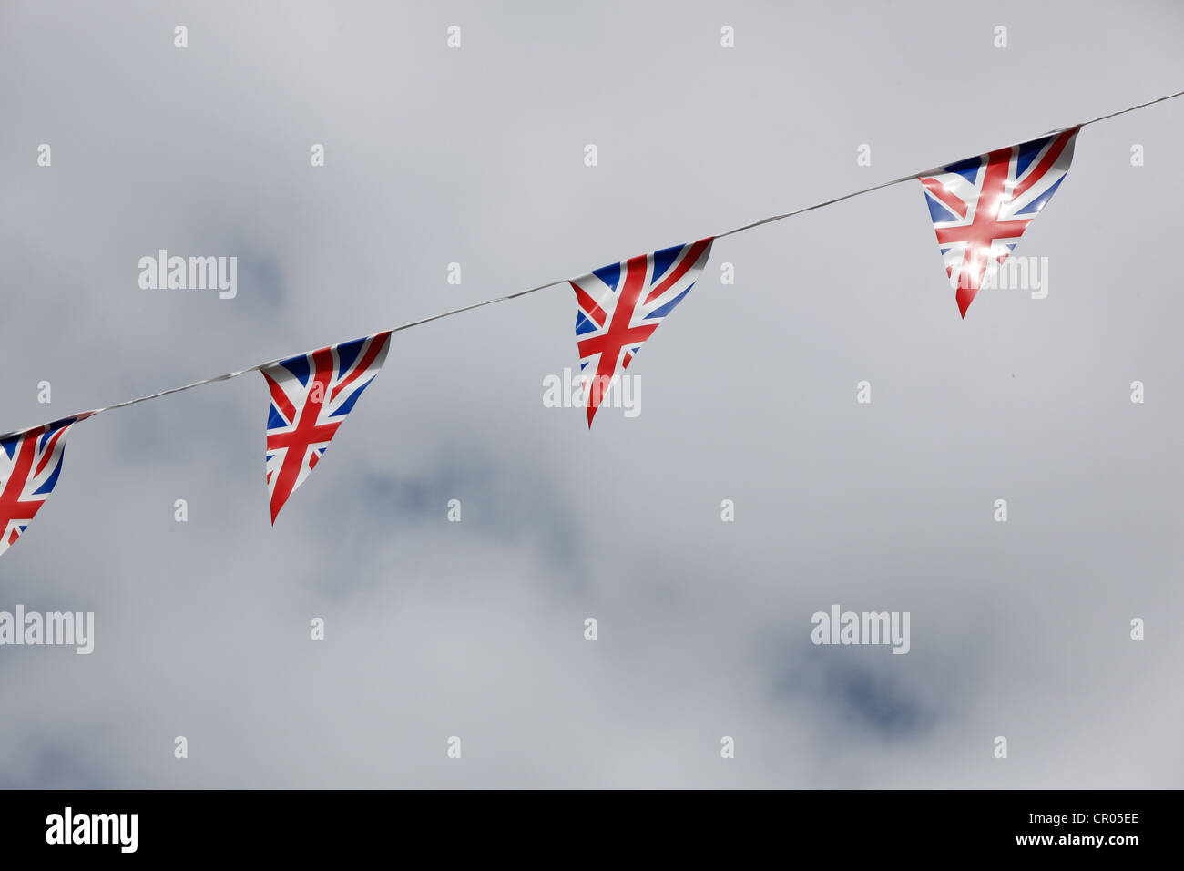 Union Jack triangular pennants strung in the air against a blue sky and ...