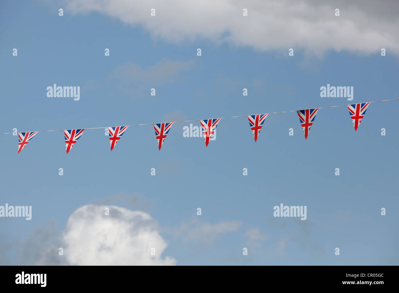 Union Jack triangular pennants strung in the air against a blue sky and ...