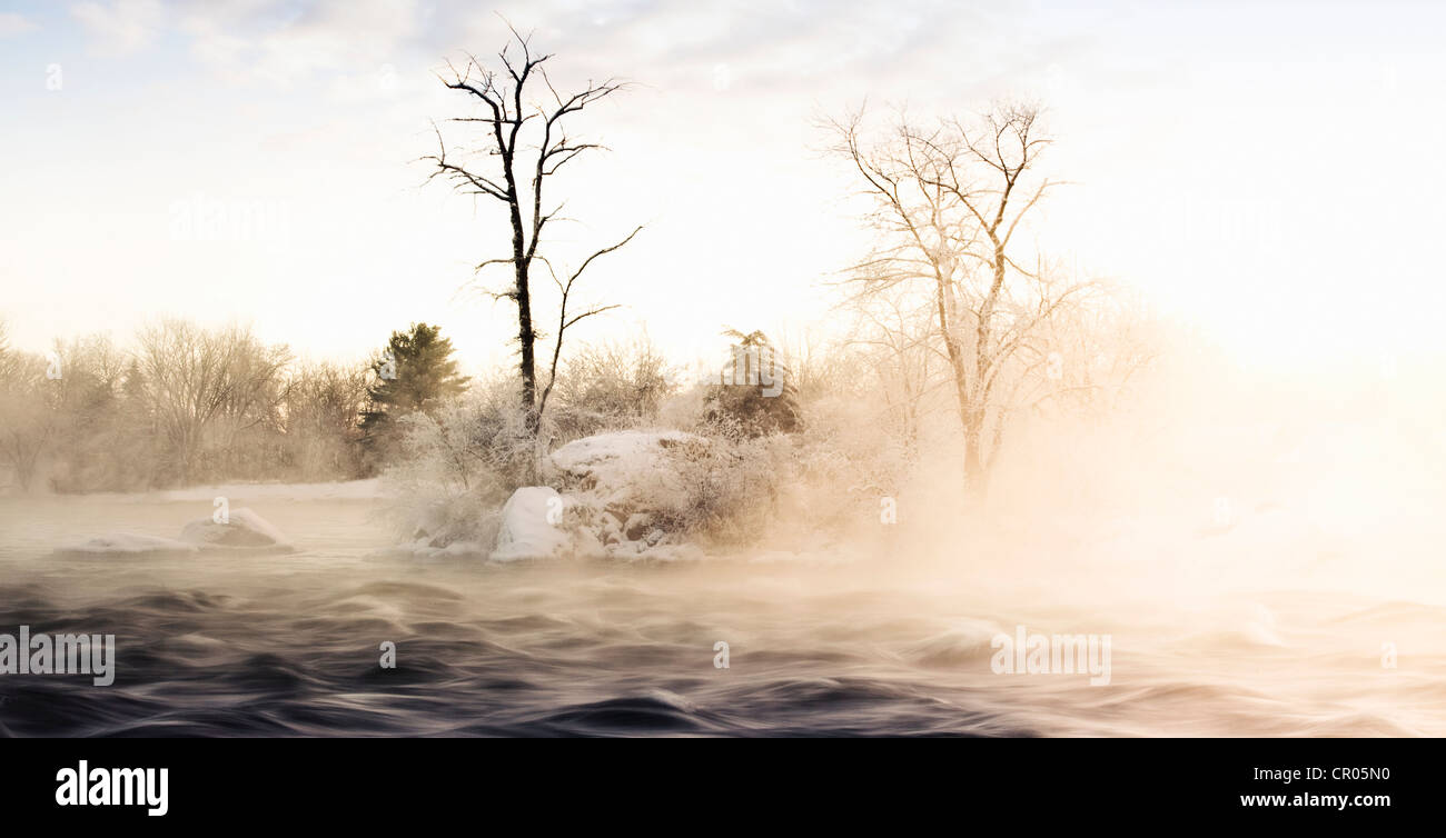 Fog rolling through snowy landscape Stock Photo - Alamy