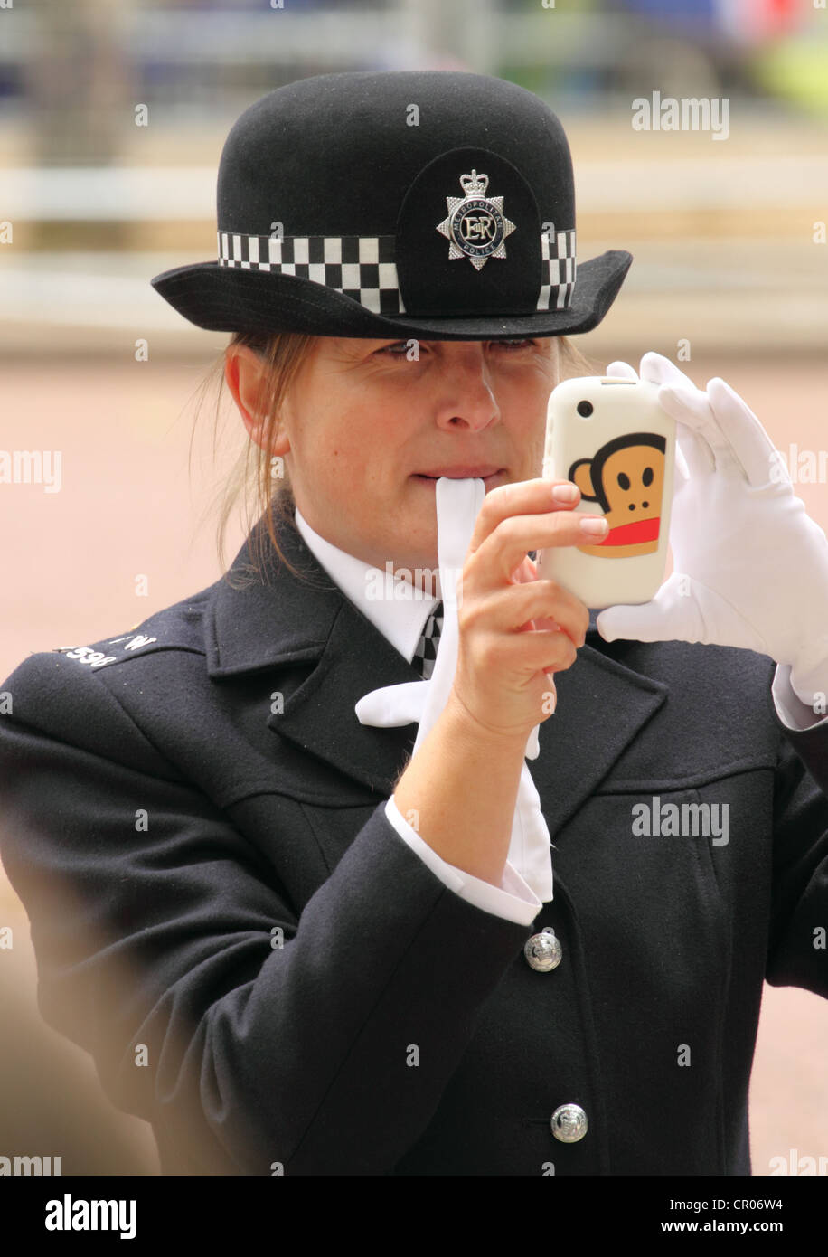 Police woman taking a photograph of the crowd on the Mall during the ...