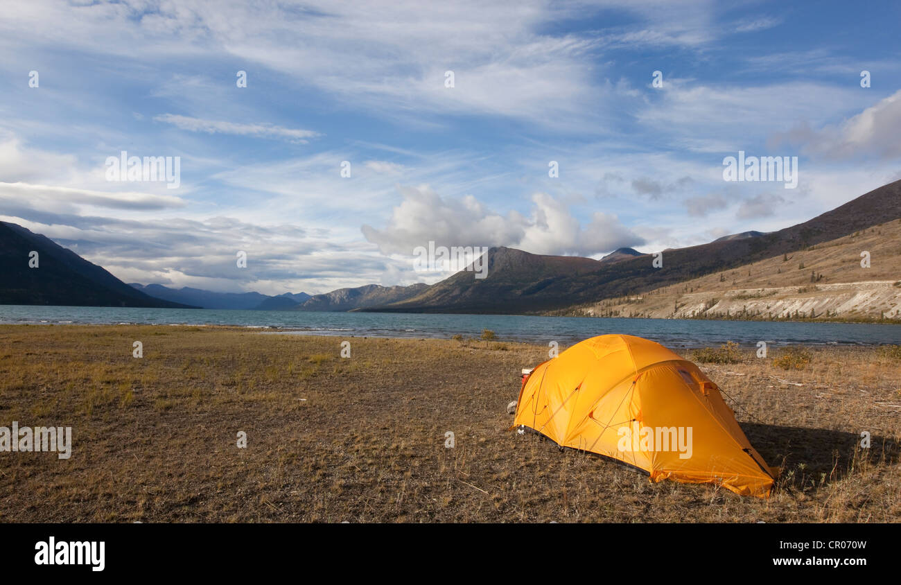 Tent on the shore of Kusawa Lake, mountains behind, Yukon Territory ...