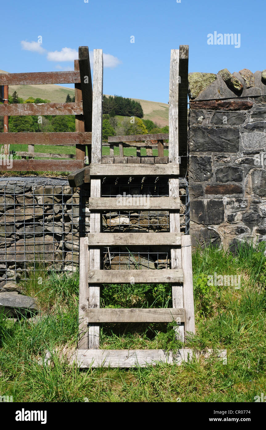 Stile leading to the River Tweed as it passes through the village of ...