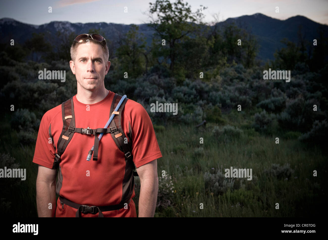 Hiker wearing backpack in hills Stock Photo - Alamy