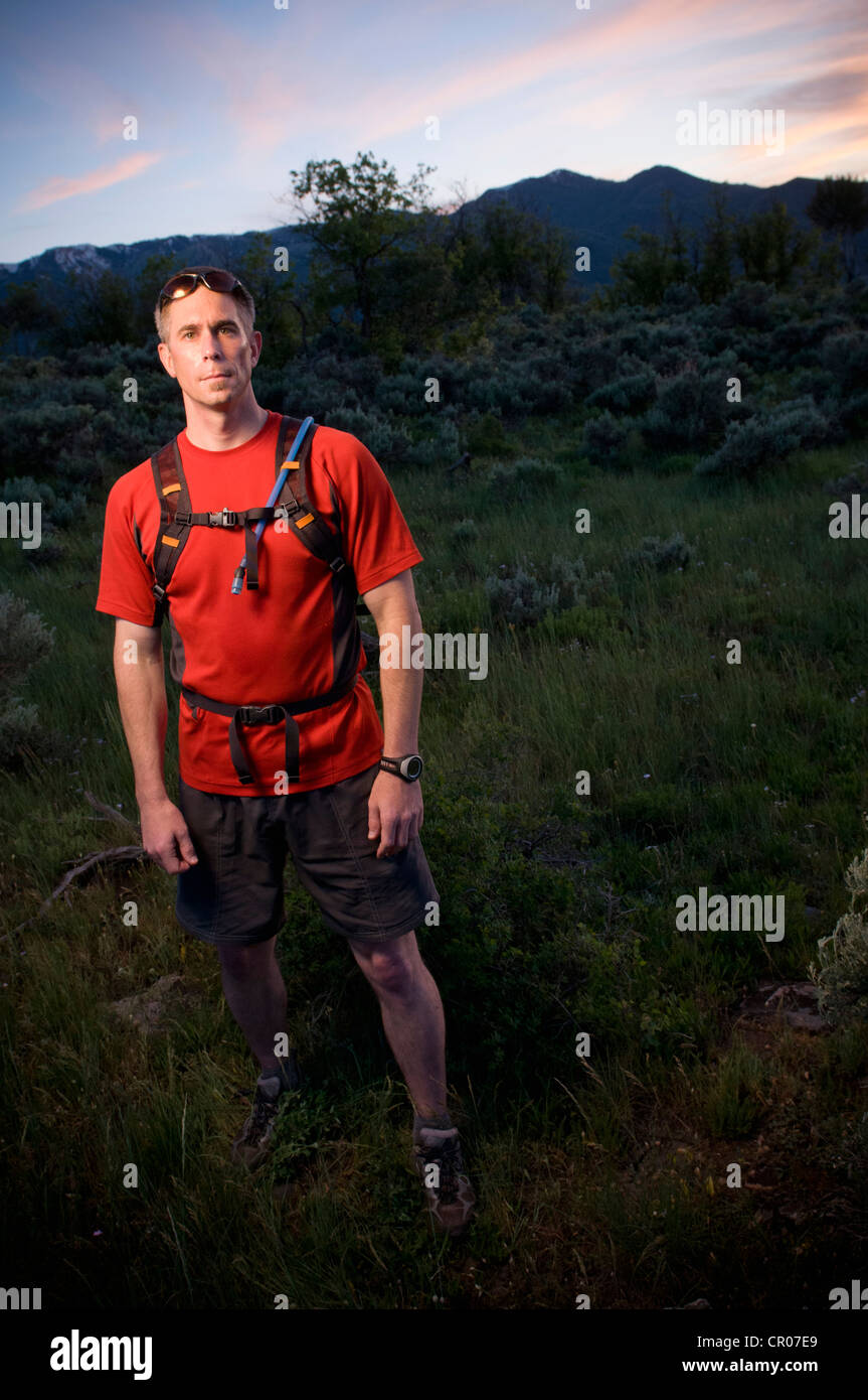 Hiker wearing backpack in hills Stock Photo - Alamy