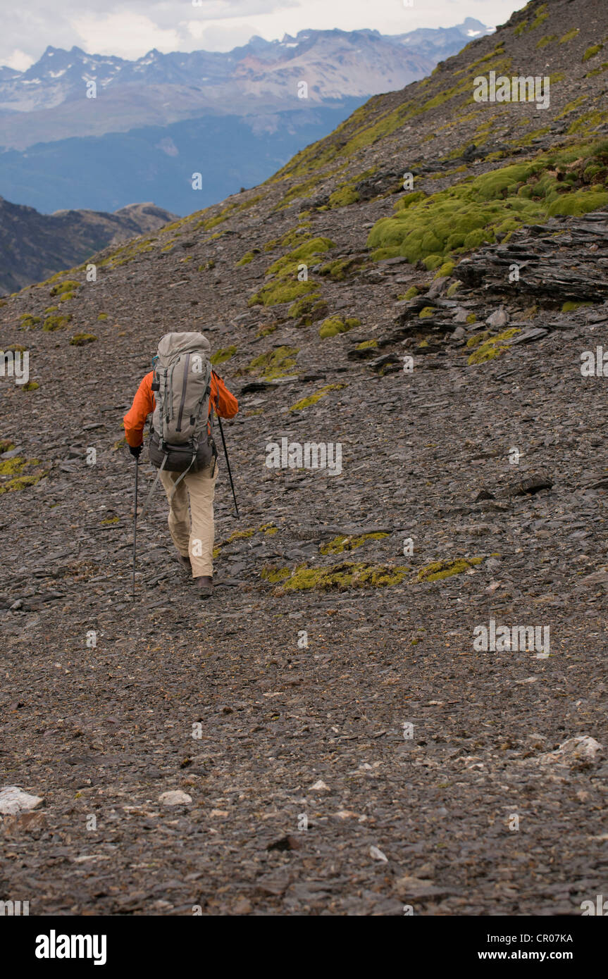 Hiker walking with sticks in rocky hills Stock Photo - Alamy
