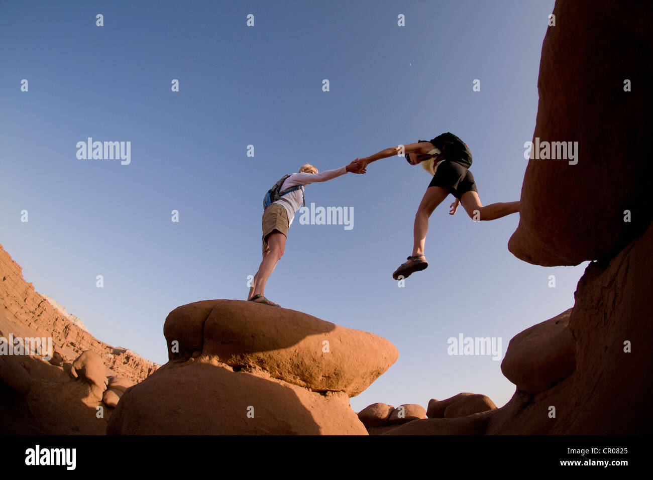Woman jumping rock formation hi-res stock photography and images - Alamy