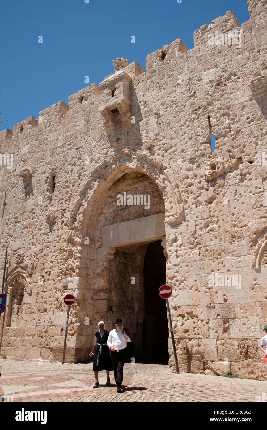 An ultra-orthodox Jewish couple passes Zion Gate in Jerusalem's Old ...