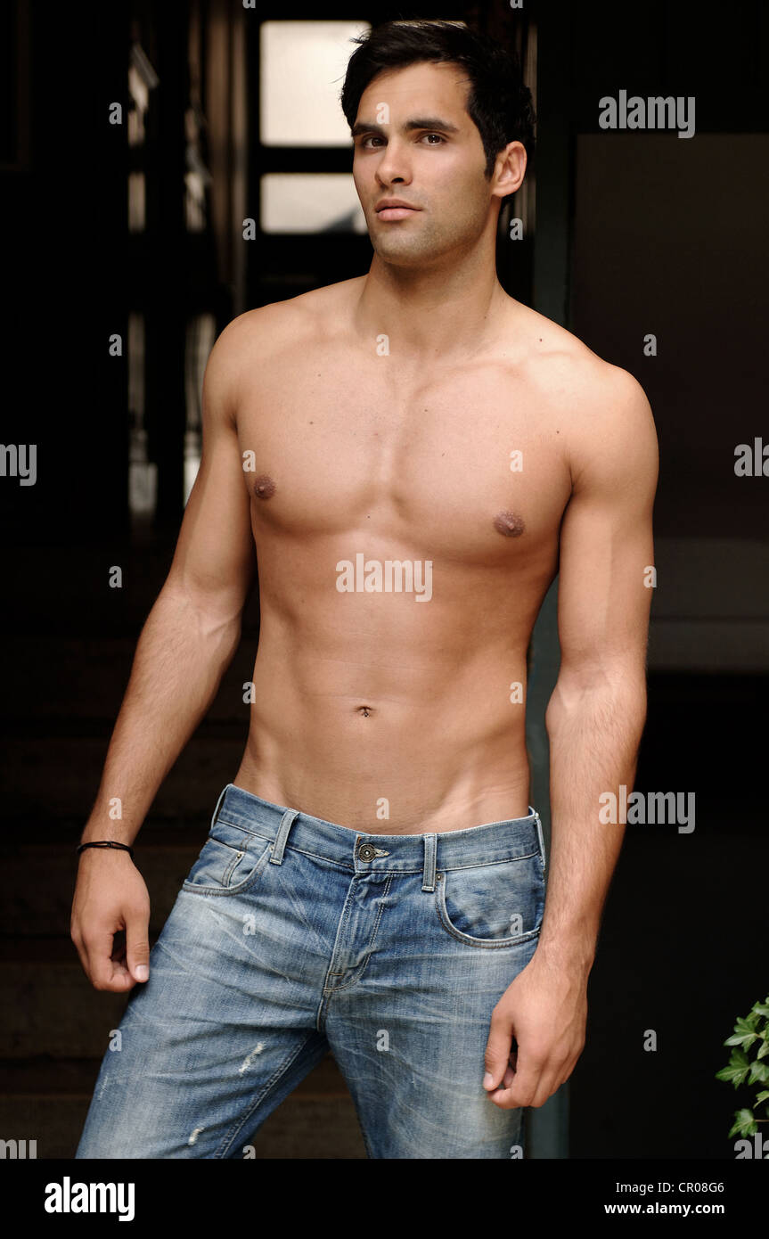 21-year-old mediterranean-looking man, wearing jeans, bare upper body ...