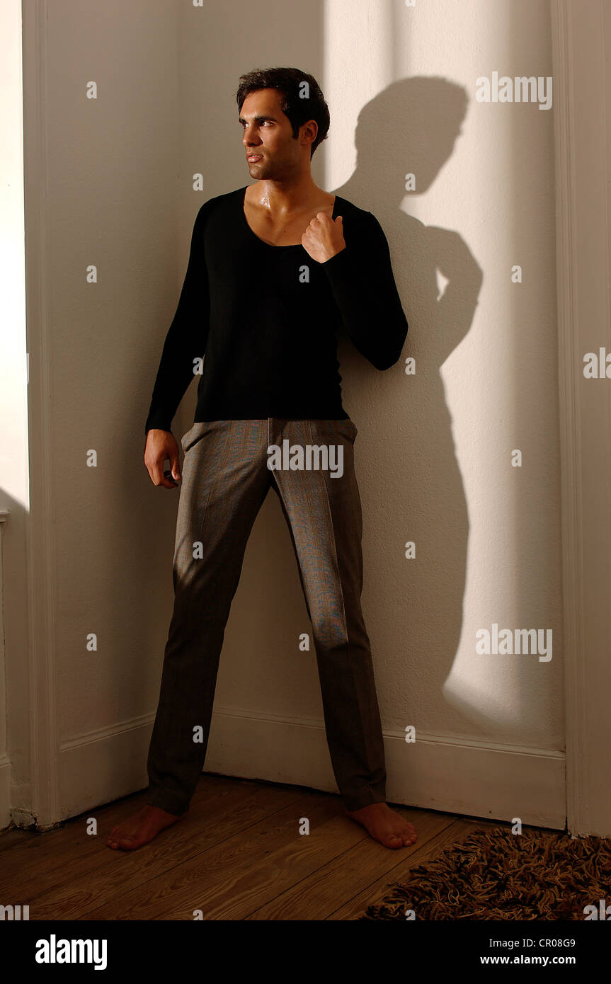 Young man standing in dark corner hi-res stock photography and images ...