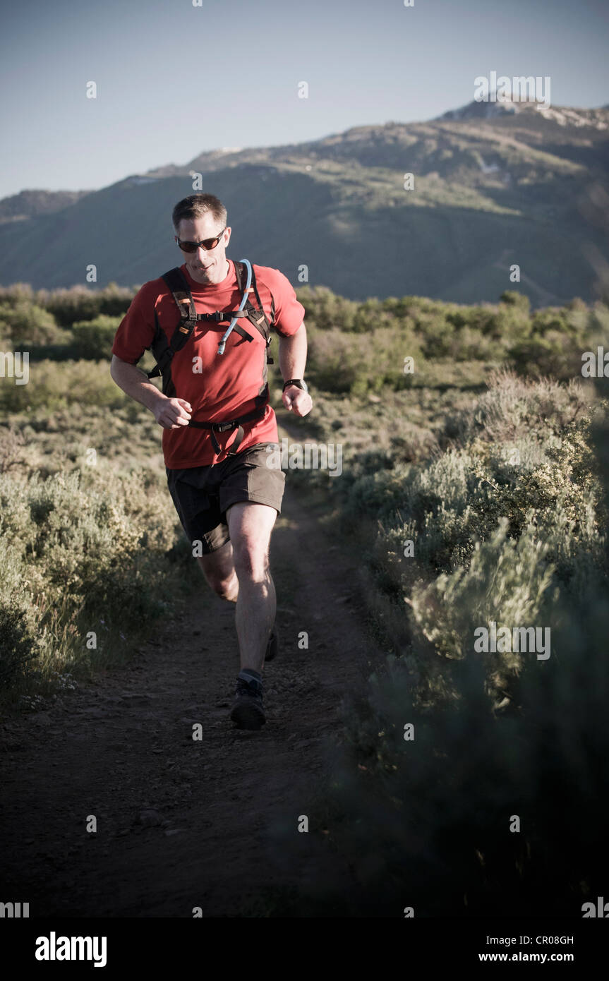 Man running in rural landscape Stock Photo - Alamy