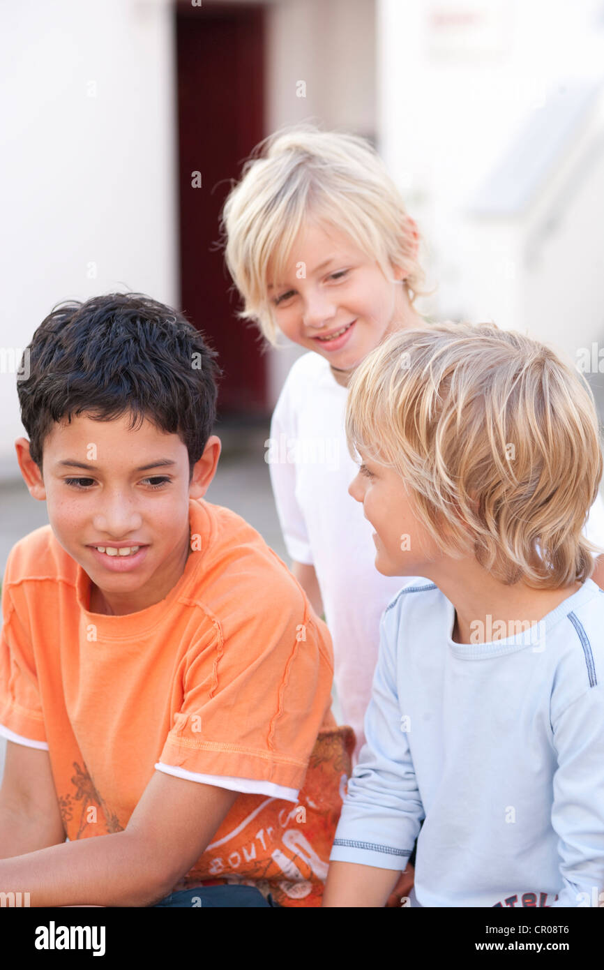 Smiling boys talking outdoors Stock Photo - Alamy