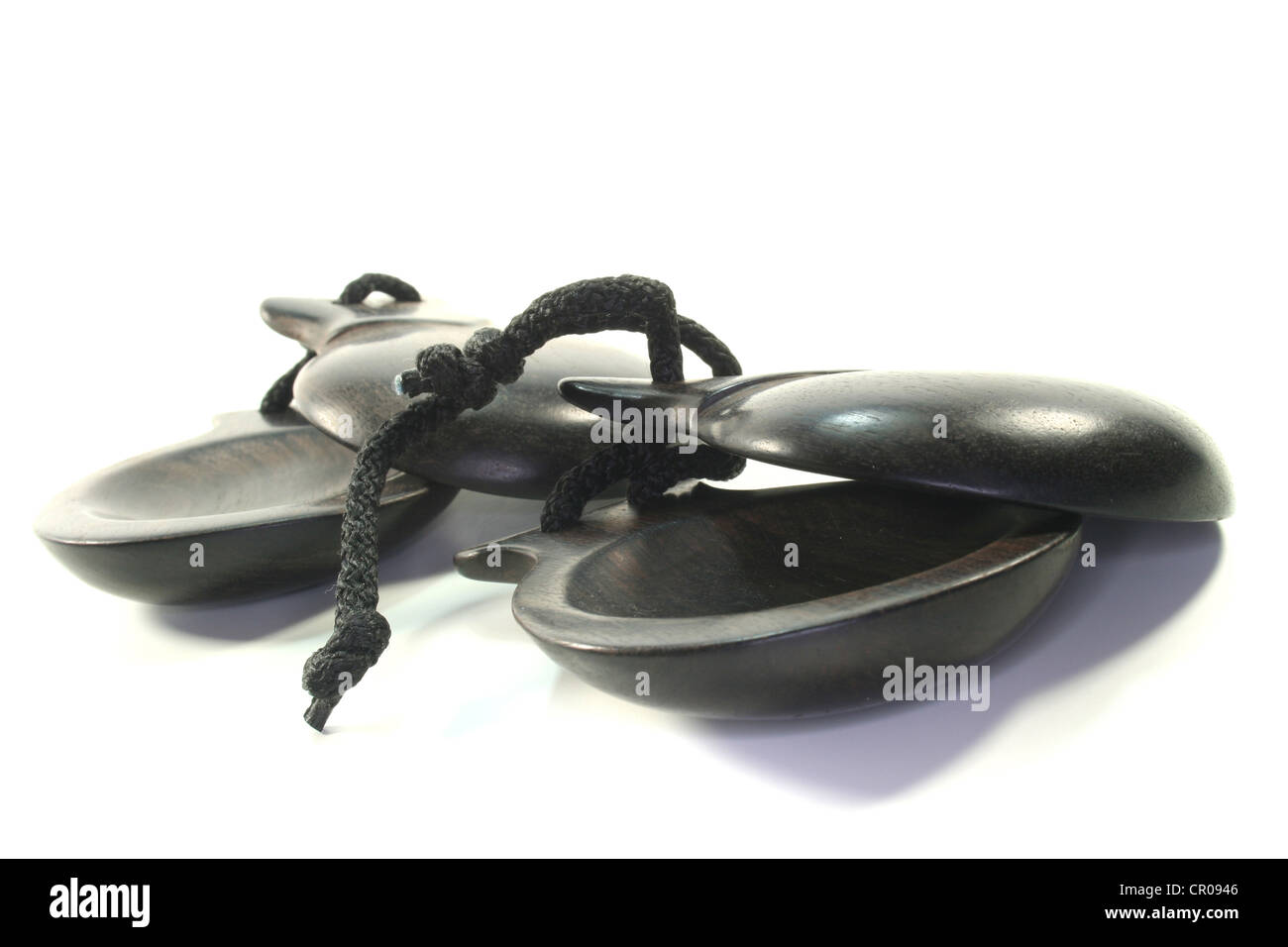 two brown castanets on a white background Stock Photo - Alamy