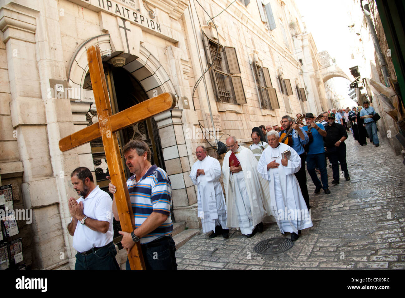 A procession of Catholic pilgrims walk the Via Dolorosa, the ...