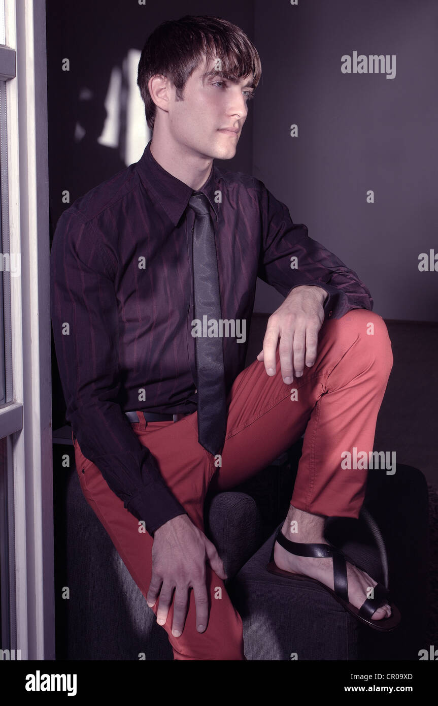Man sitting at the window, fashion shoot Stock Photo - Alamy