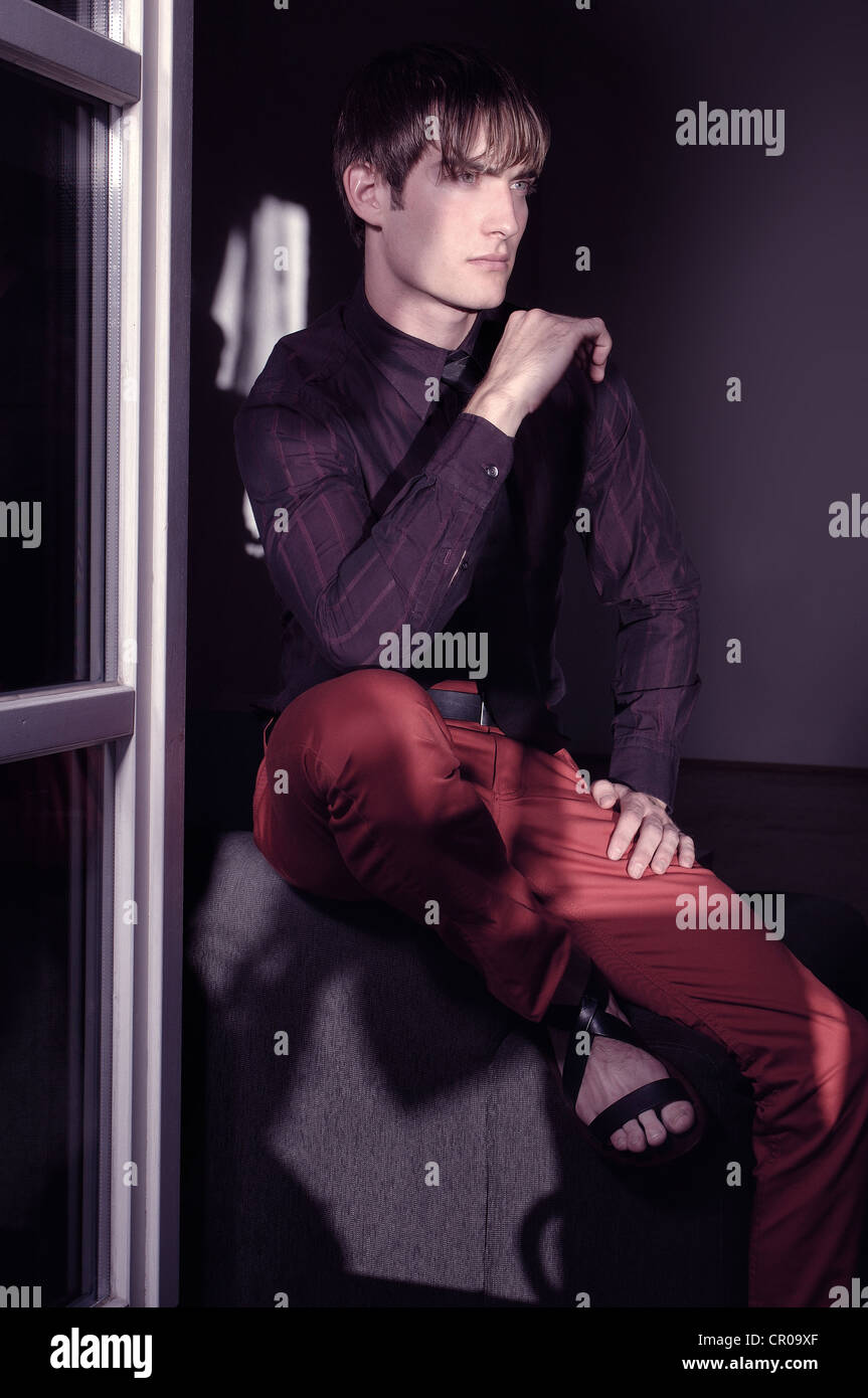 Man sitting at the window, fashion shoot Stock Photo - Alamy