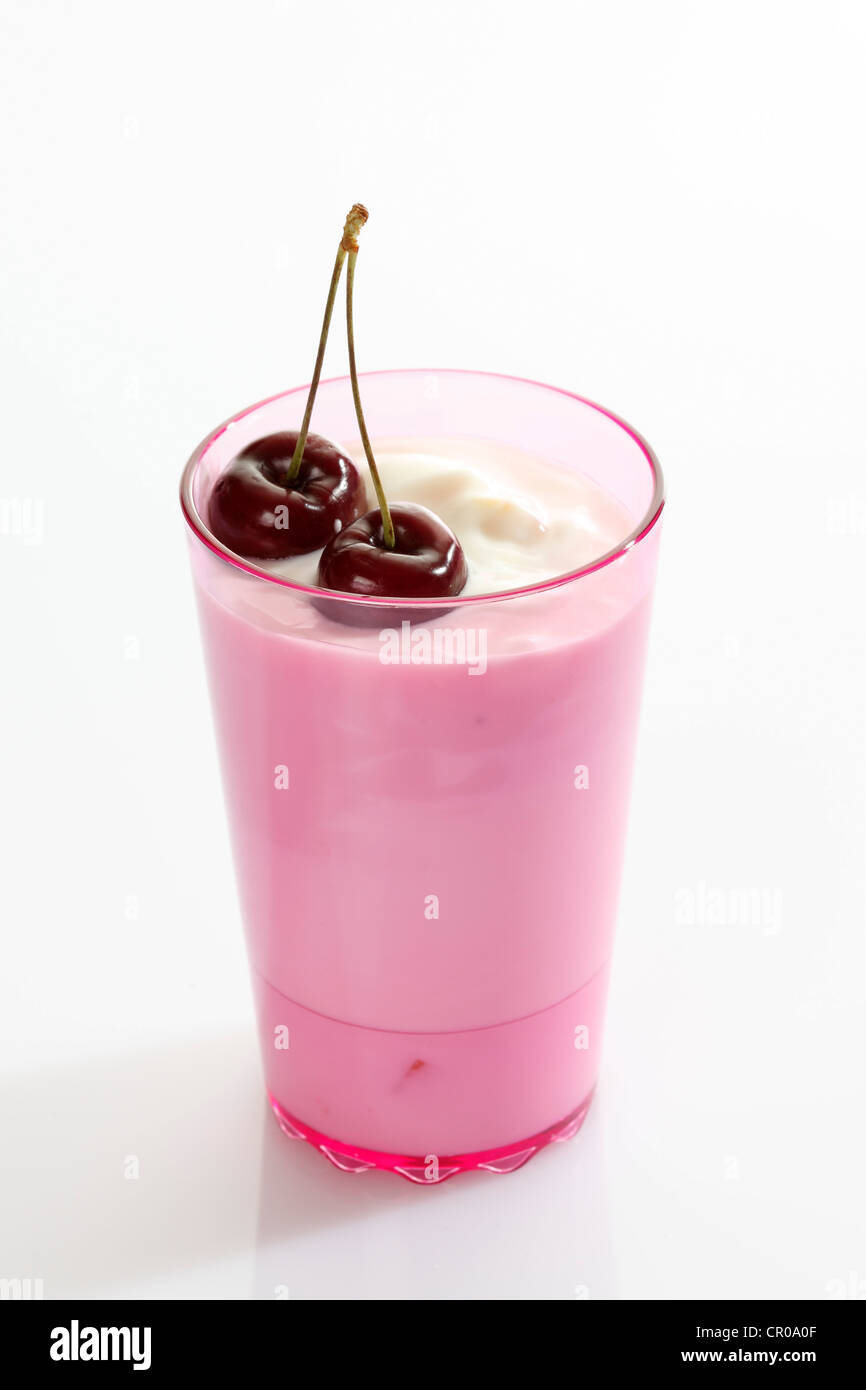 Pink cup with yoghurt and cherries Stock Photo - Alamy
